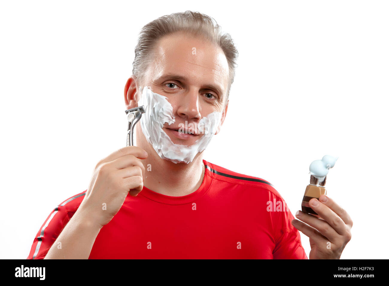 Man has a shave with the razor Stock Photo - Alamy