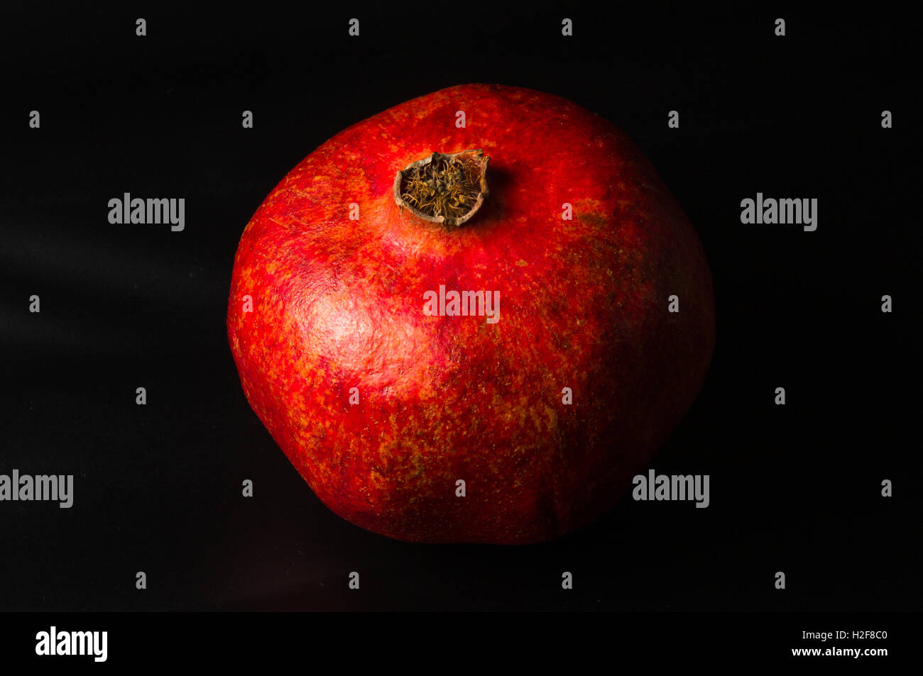 Big Pomegranate fruit on black background, closeup Stock Photo - Alamy