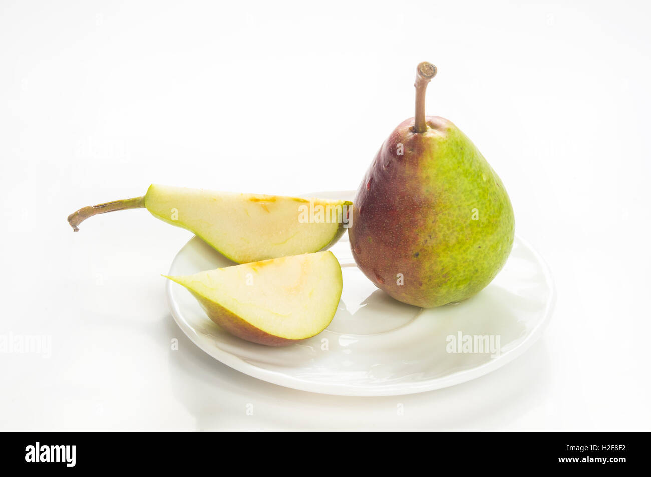 colorful pears and slices in the dish on a white background Stock Photo ...