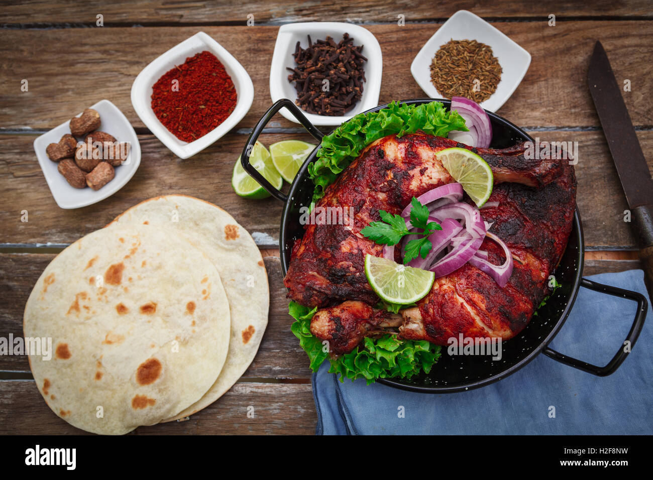 Indian tandoori leg chicken with spices and vegetables Stock Photo - Alamy