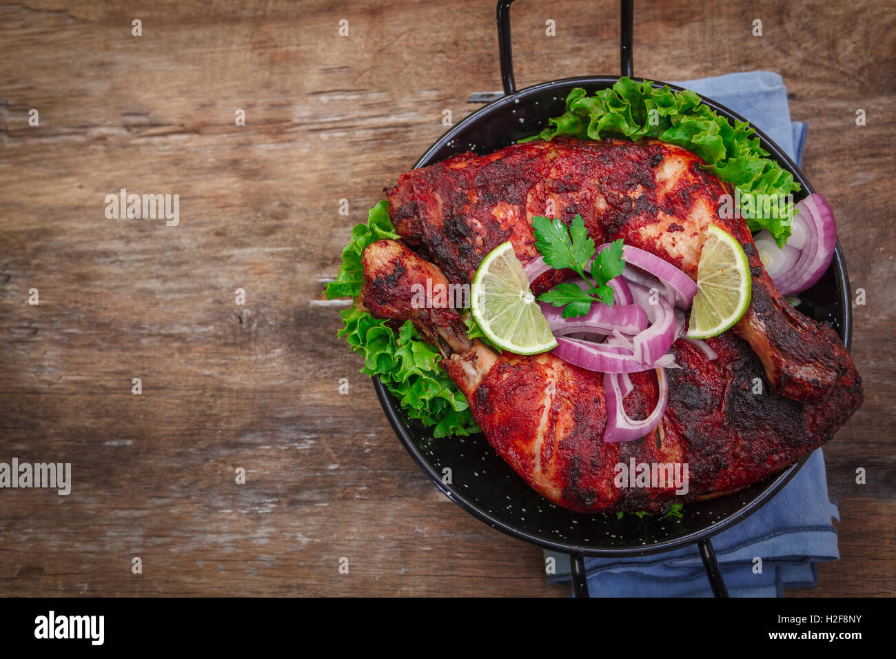 Indian tandoori leg chicken with spices and vegetables Stock Photo - Alamy