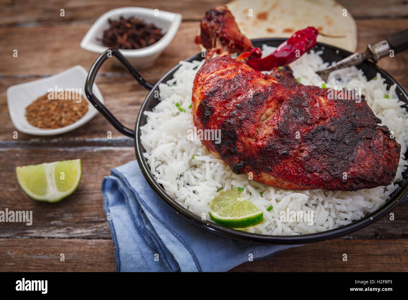 Indian tandoori leg chicken with spices and vegetables Stock Photo - Alamy