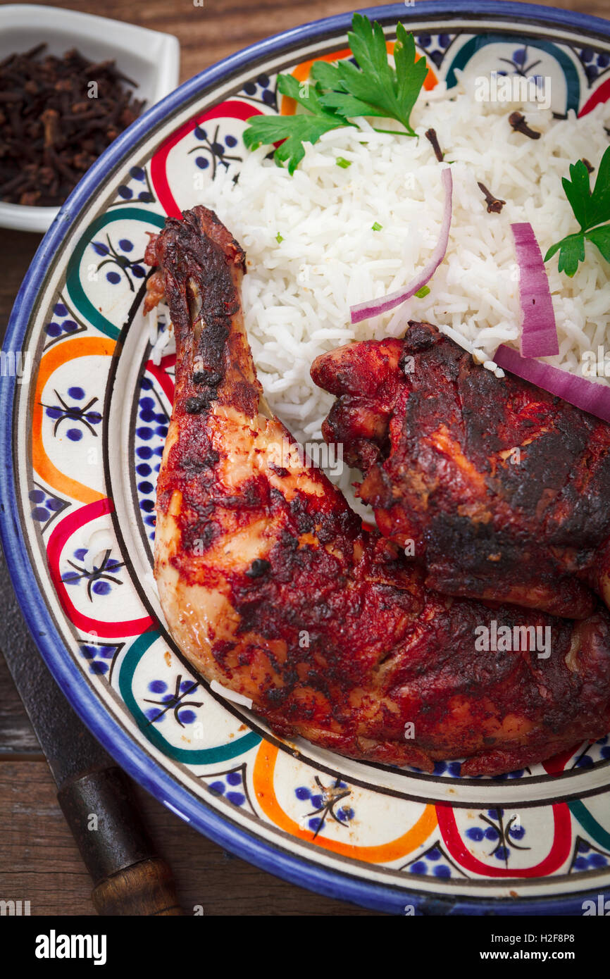 Indian tandoori leg chicken with spices and vegetables Stock Photo - Alamy