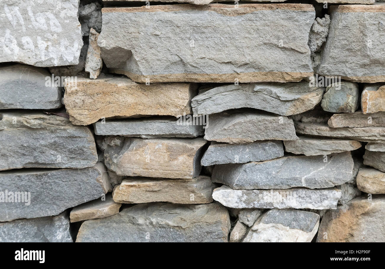 Fragment of the ancient stone wall executed from stones of various form ...