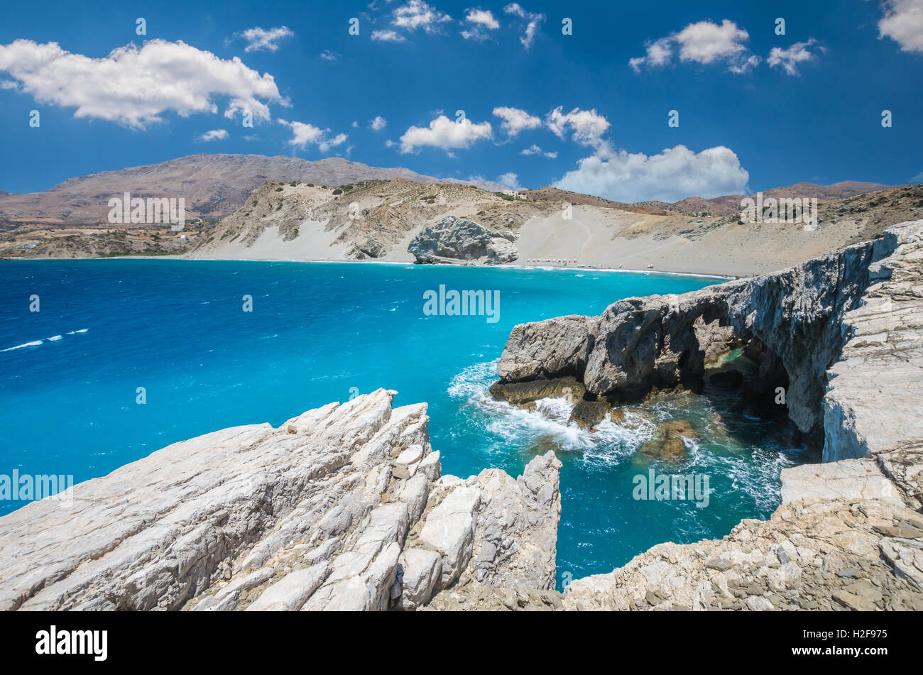 Agios Pavlos Beach in Crete island, Greece. Tourists relax and bath in crystal clear water of St ...
