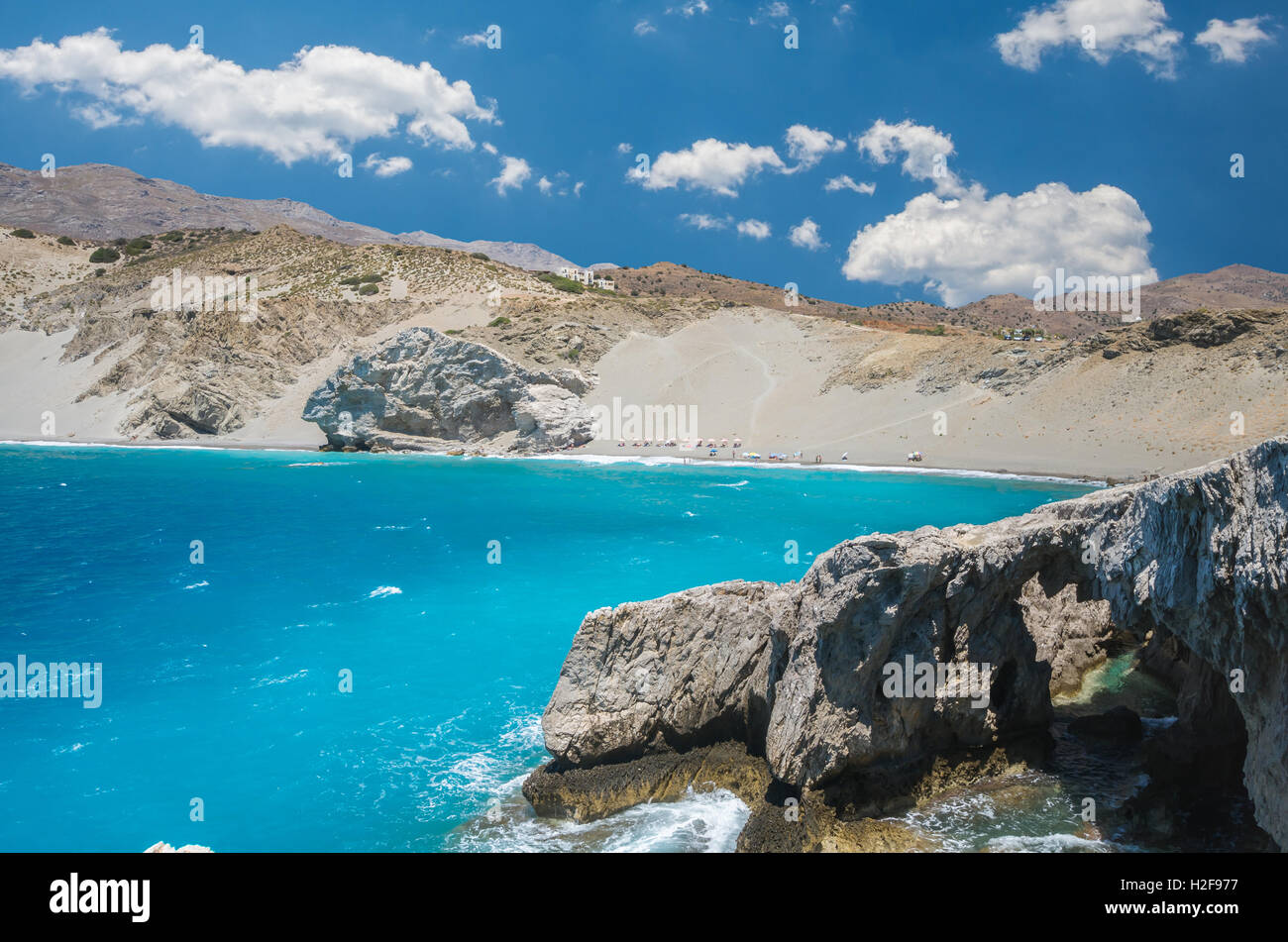 Agios Pavlos Beach in Crete island, Greece. Tourists relax and bath in crystal clear water of St ...