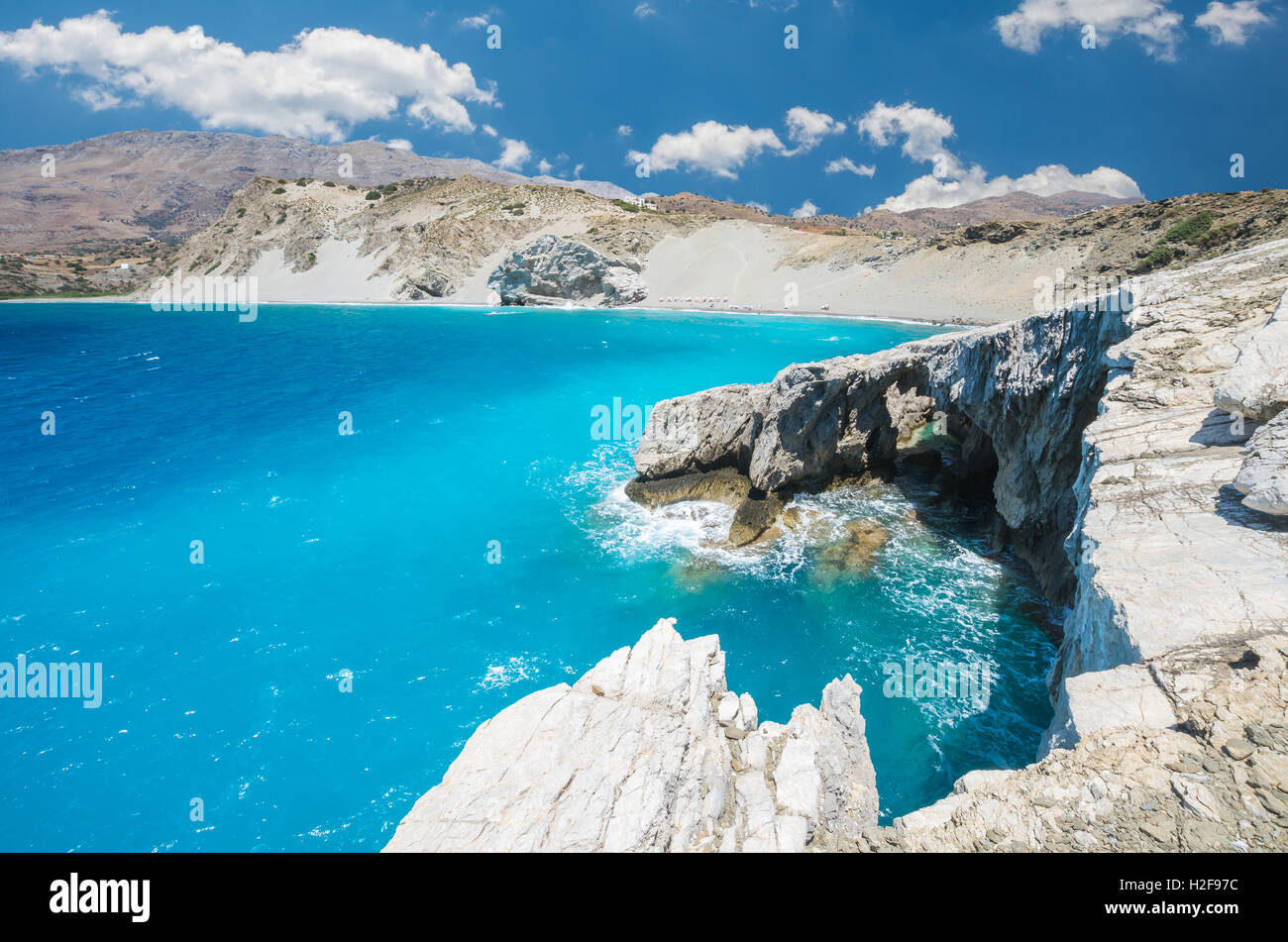 Agios Pavlos Beach in Crete island, Greece. Tourists relax and bath in crystal clear water of St ...
