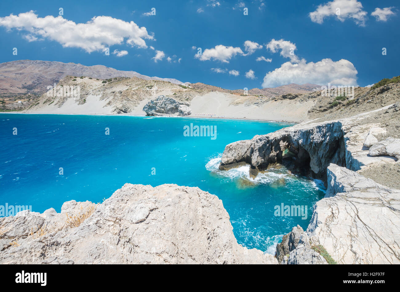 Agios Pavlos Beach in Crete island, Greece. Tourists relax and bath in crystal clear water of St ...