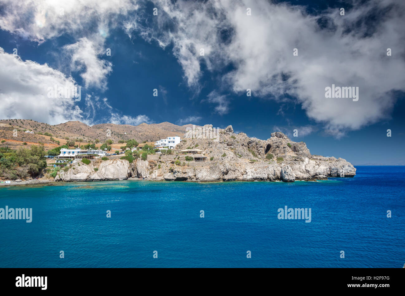 Agios Pavlos Beach in Crete island, Greece. Tourists relax and bath in crystal clear water of St ...