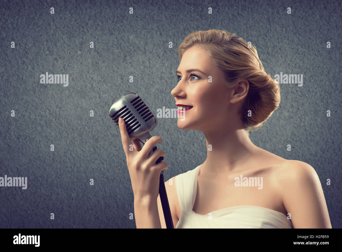 attractive female singer with microphone Stock Photo - Alamy