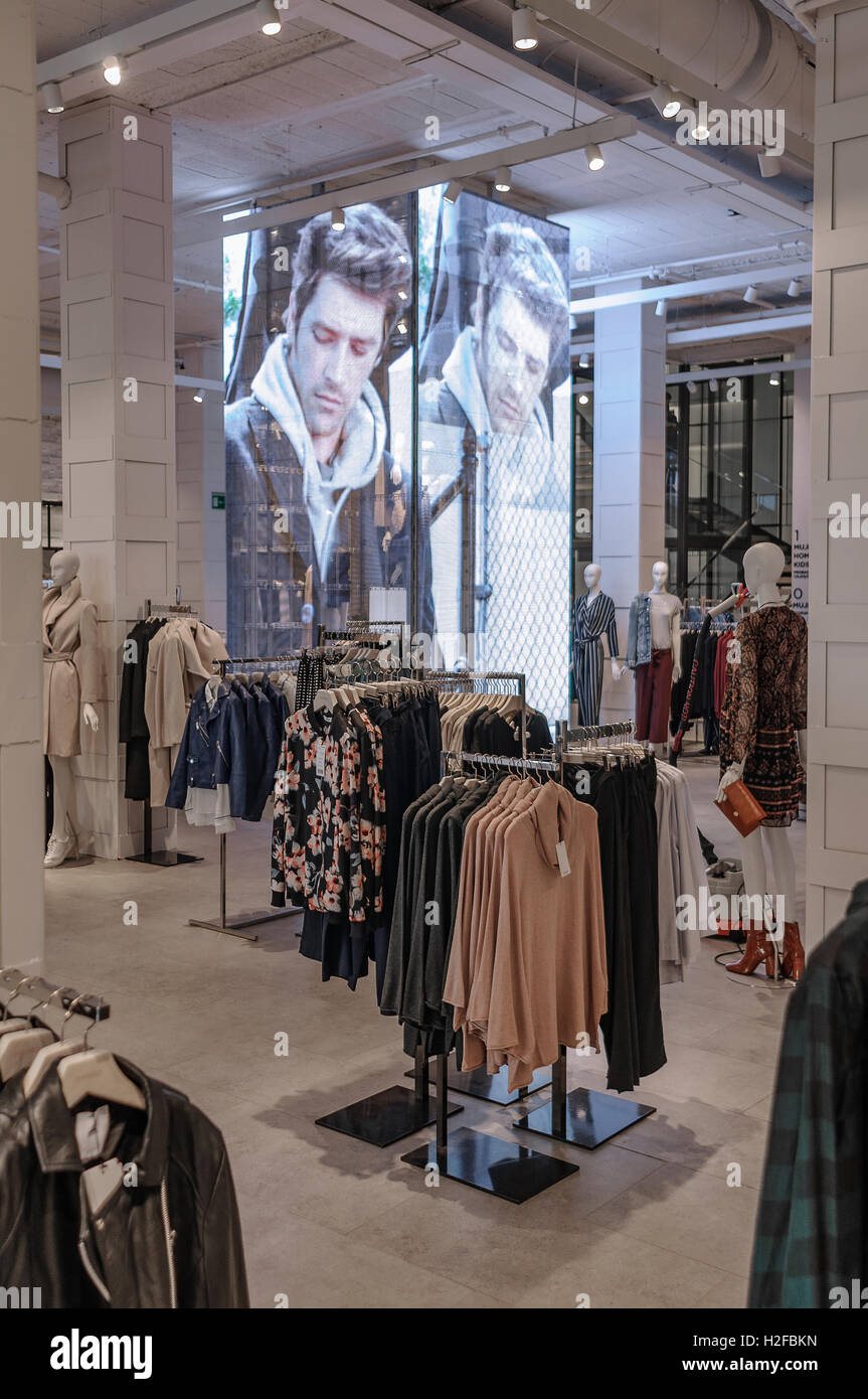 Interior of a clothing store with illuminated advertising in the city ...