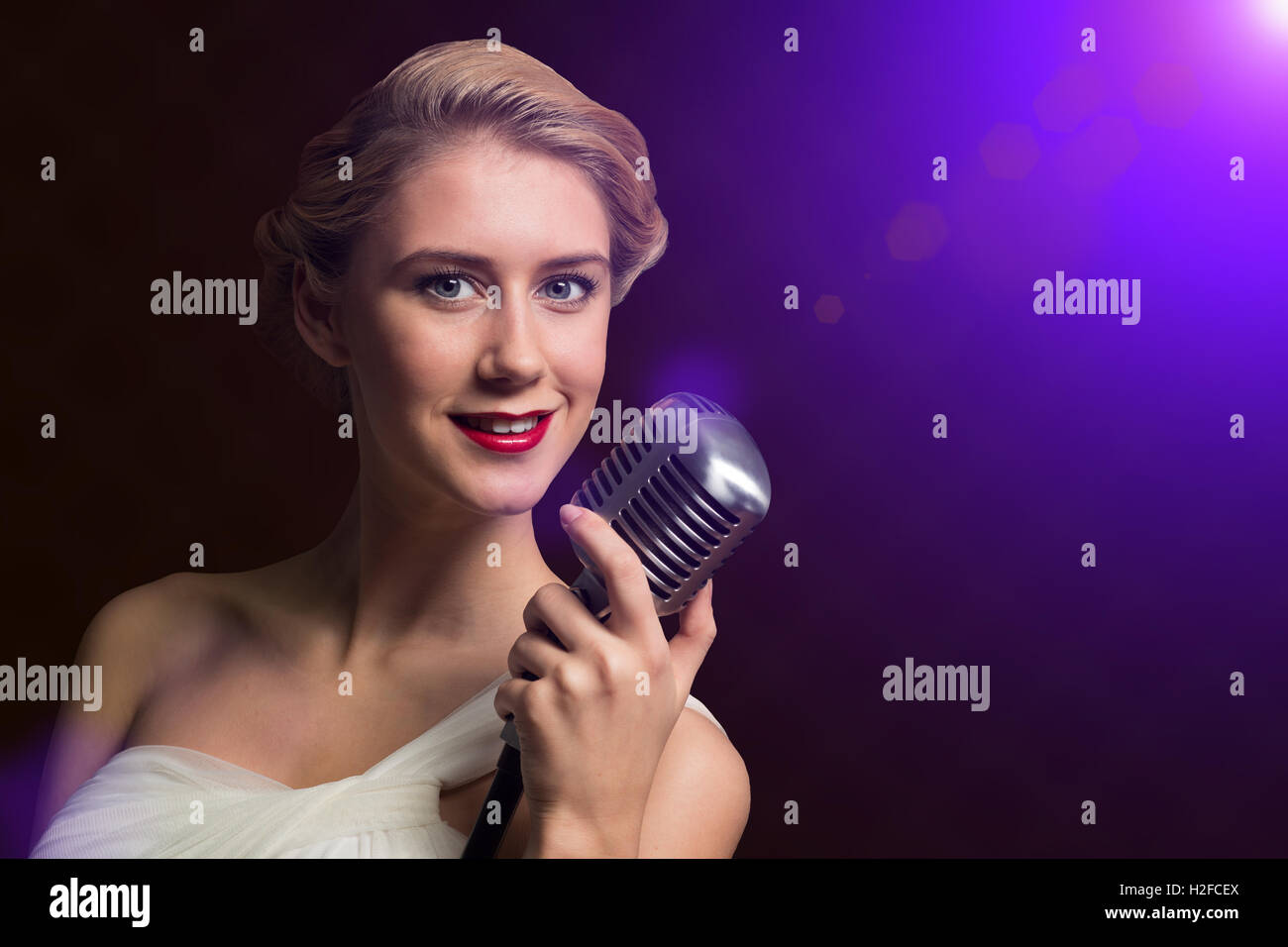 attractive female singer with microphone Stock Photo - Alamy