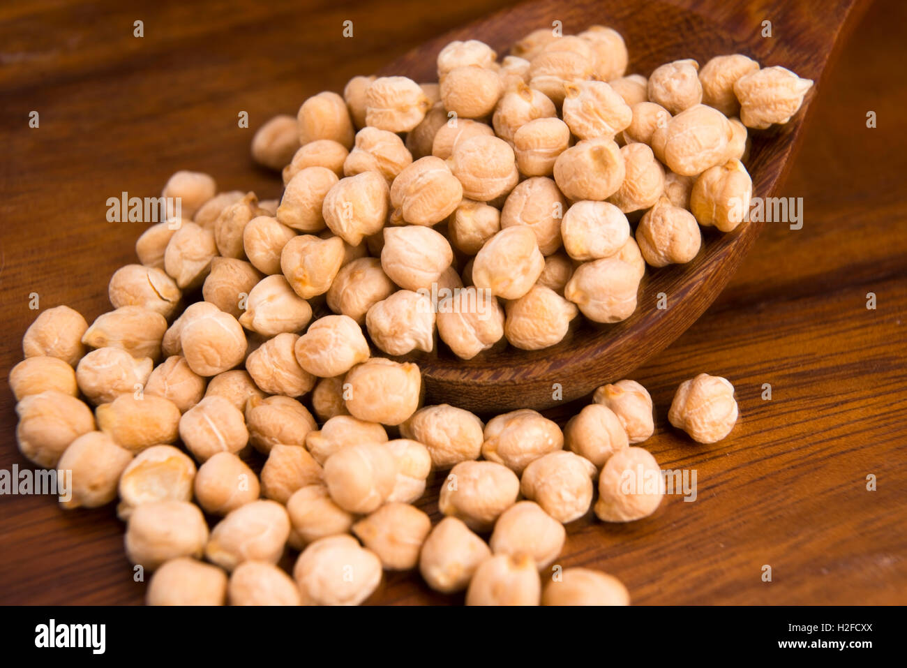 dried white chickpeas ceci on the wooden spoon Stock Photo - Alamy
