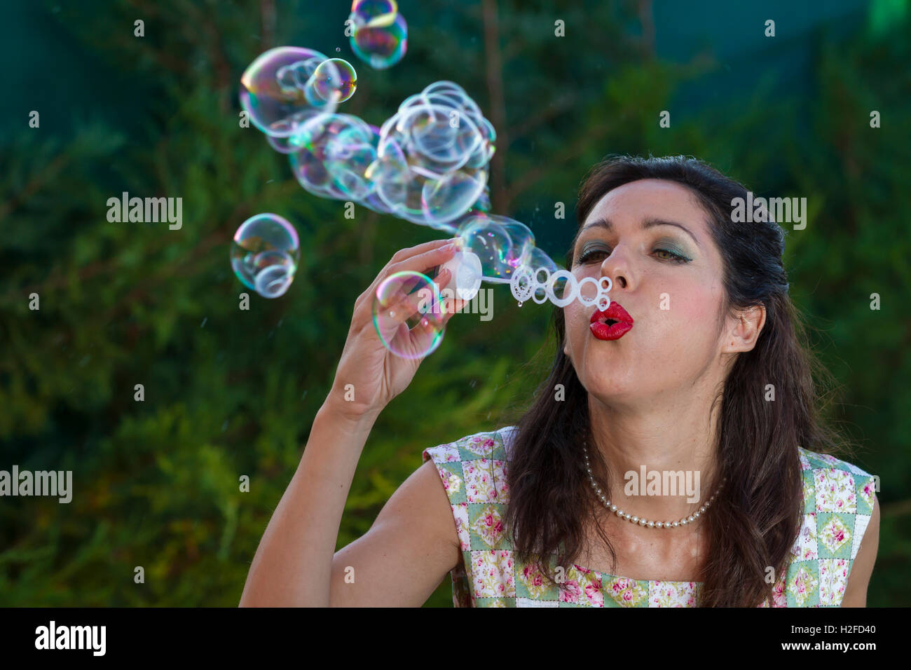 a beautiful woman blowing bubbles. spring season, rural scene Stock ...