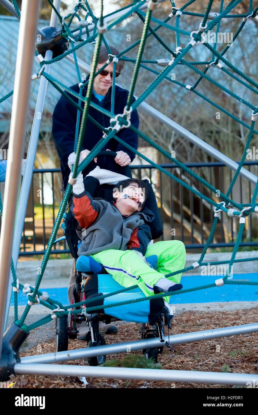 Father with disabled boy at the playground Stock Photo - Alamy