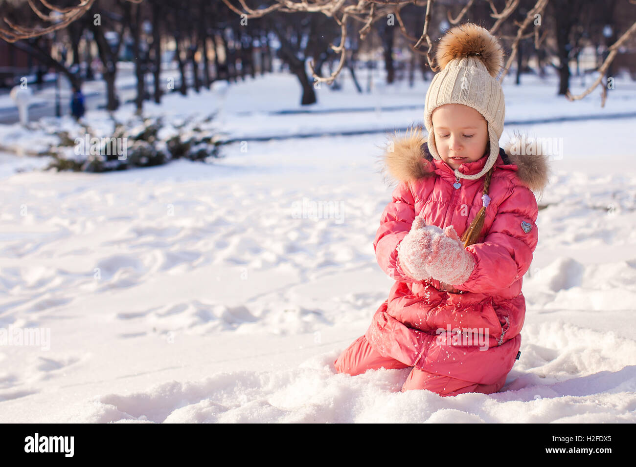 Adorable little girl have fun outdoor on cold winter day Stock Photo ...