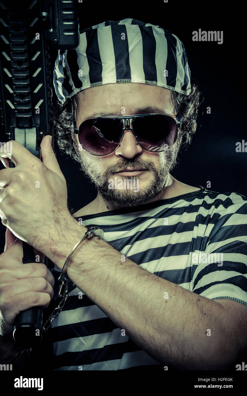 Fight, Prison riot concept. Man holding a machine gun, prisoner Stock ...