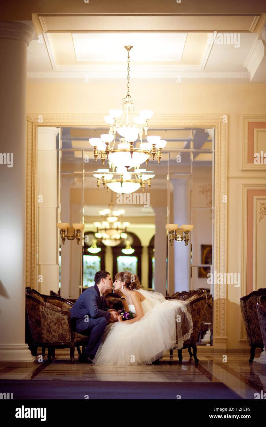 bride and groom in golden hall Stock Photo - Alamy