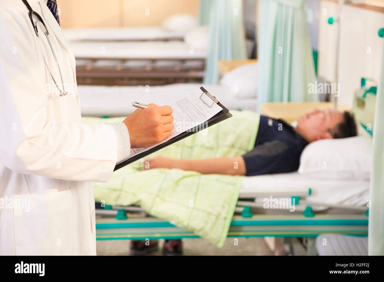 doctor records patients medical situation Stock Photo - Alamy
