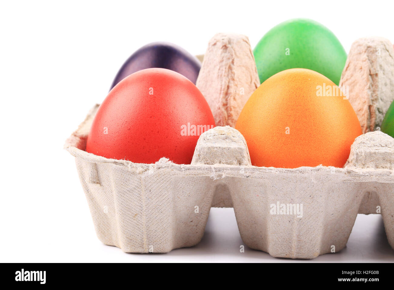 Cardboard egg box with Easter colored eggs Stock Photo - Alamy