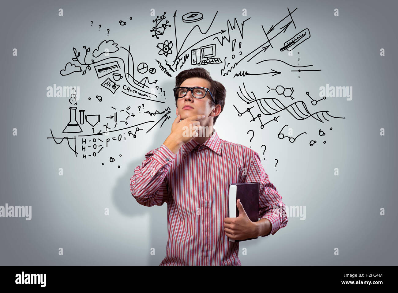 young man scientist with glasses thinking Stock Photo - Alamy