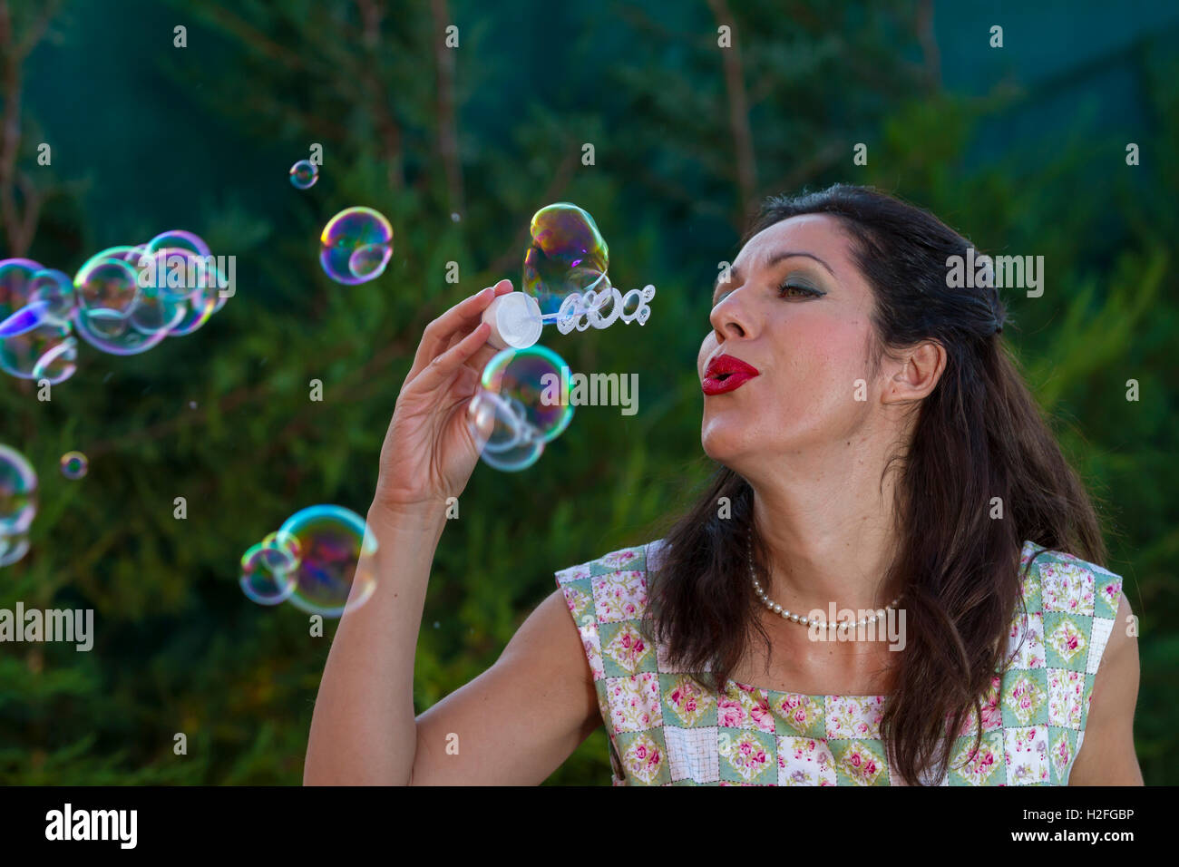 a beautiful woman blowing bubbles. spring season, rural scene Stock ...