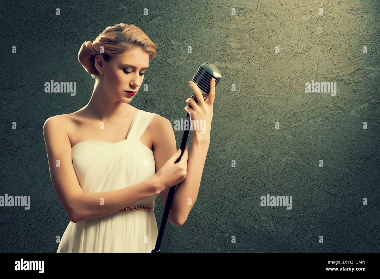 attractive female singer with microphone Stock Photo - Alamy