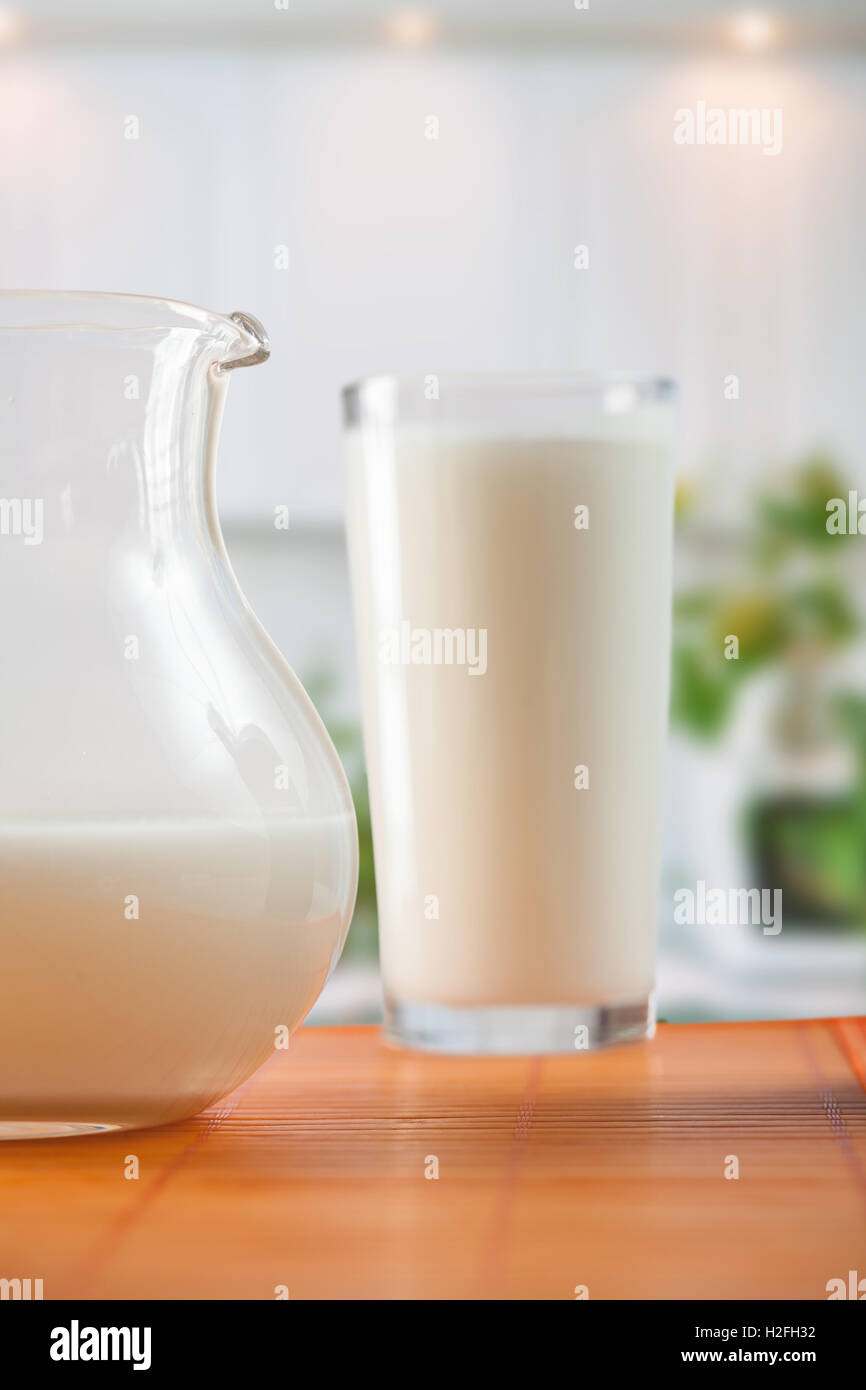 milk in glass and jug on table Stock Photo - Alamy