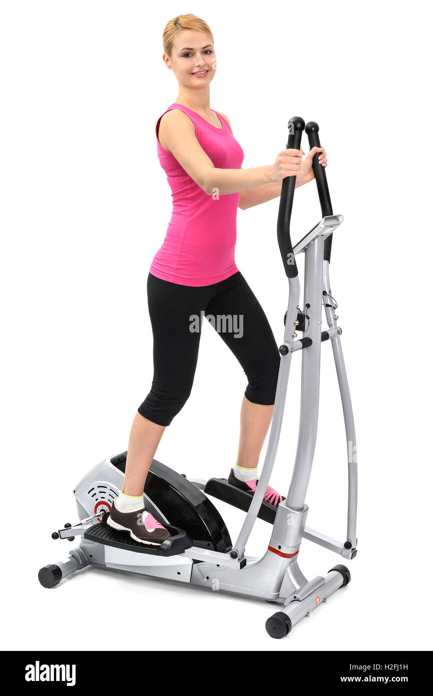 young woman doing exercises on elliptical trainer Stock Photo - Alamy