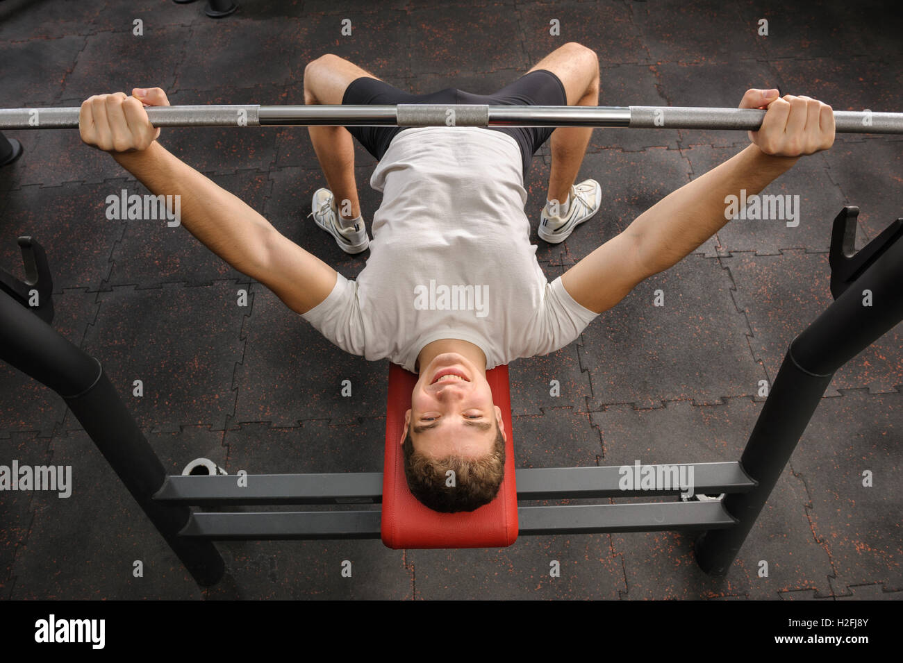 young man doing bench press workout in gym Stock Photo - Alamy
