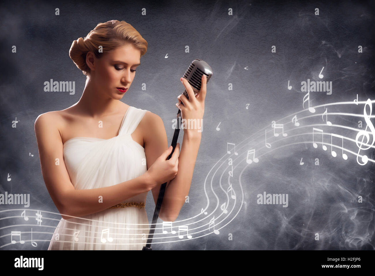attractive female singer with microphone Stock Photo - Alamy