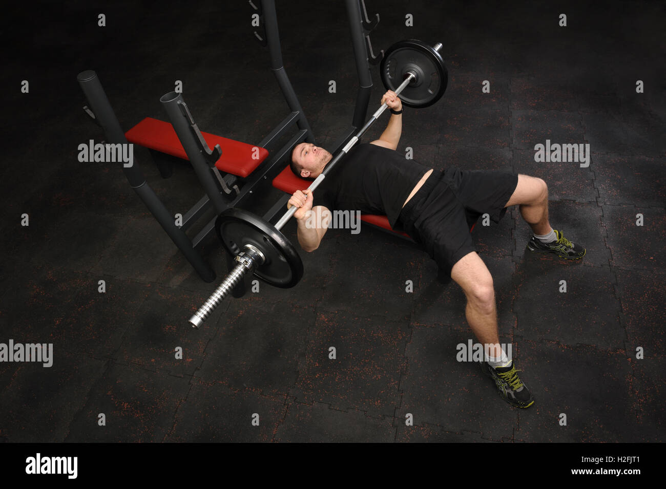 young man doing bench press workout in gym Stock Photo - Alamy
