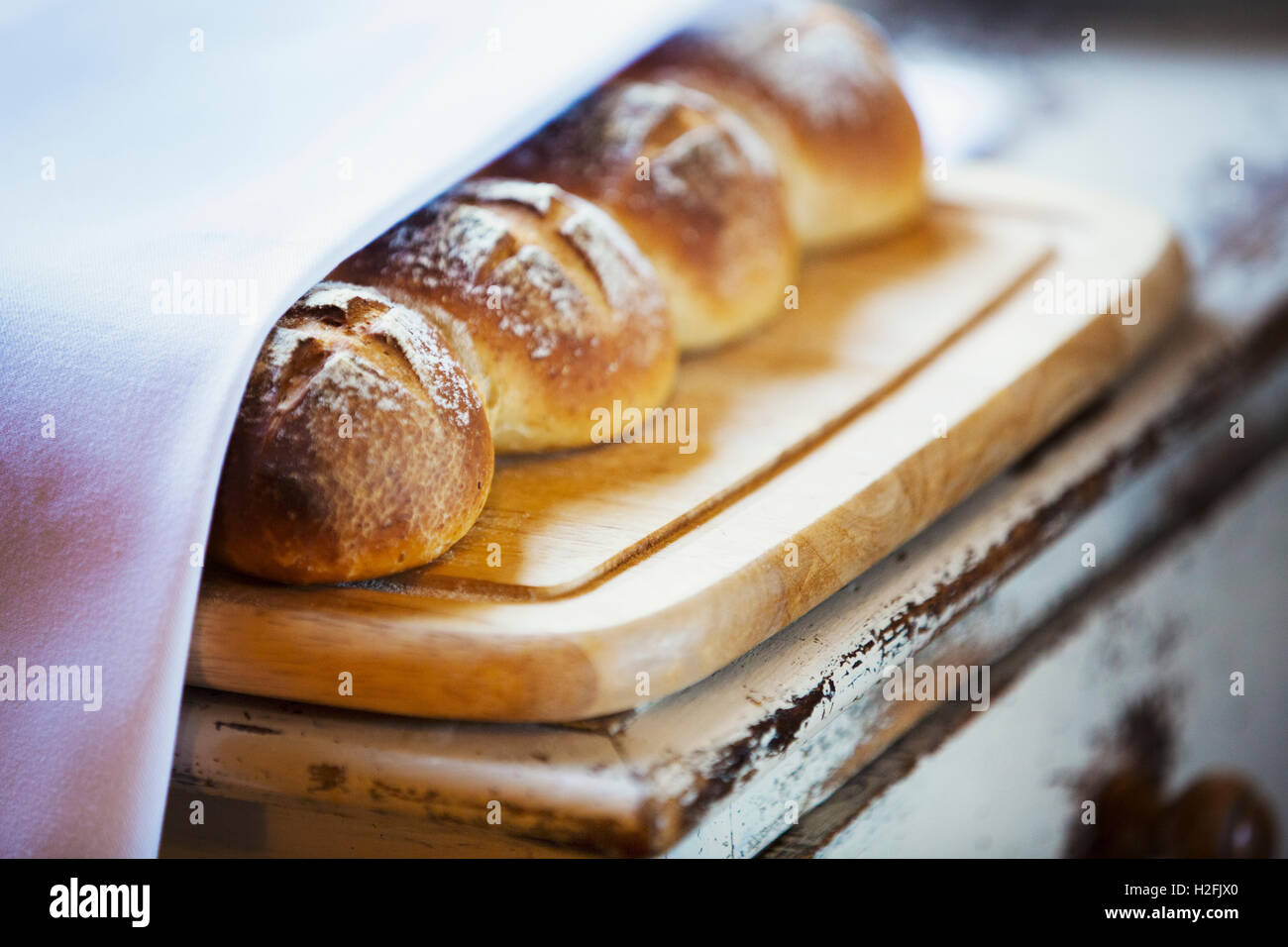 Village public house kitchen. Fresh baked batch bread rolls covered by ...