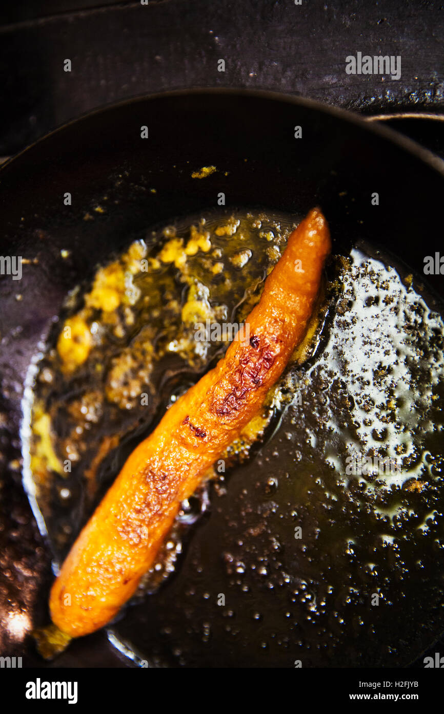 A freshly cooked whole carrot in a frying pan Stock Photo - Alamy