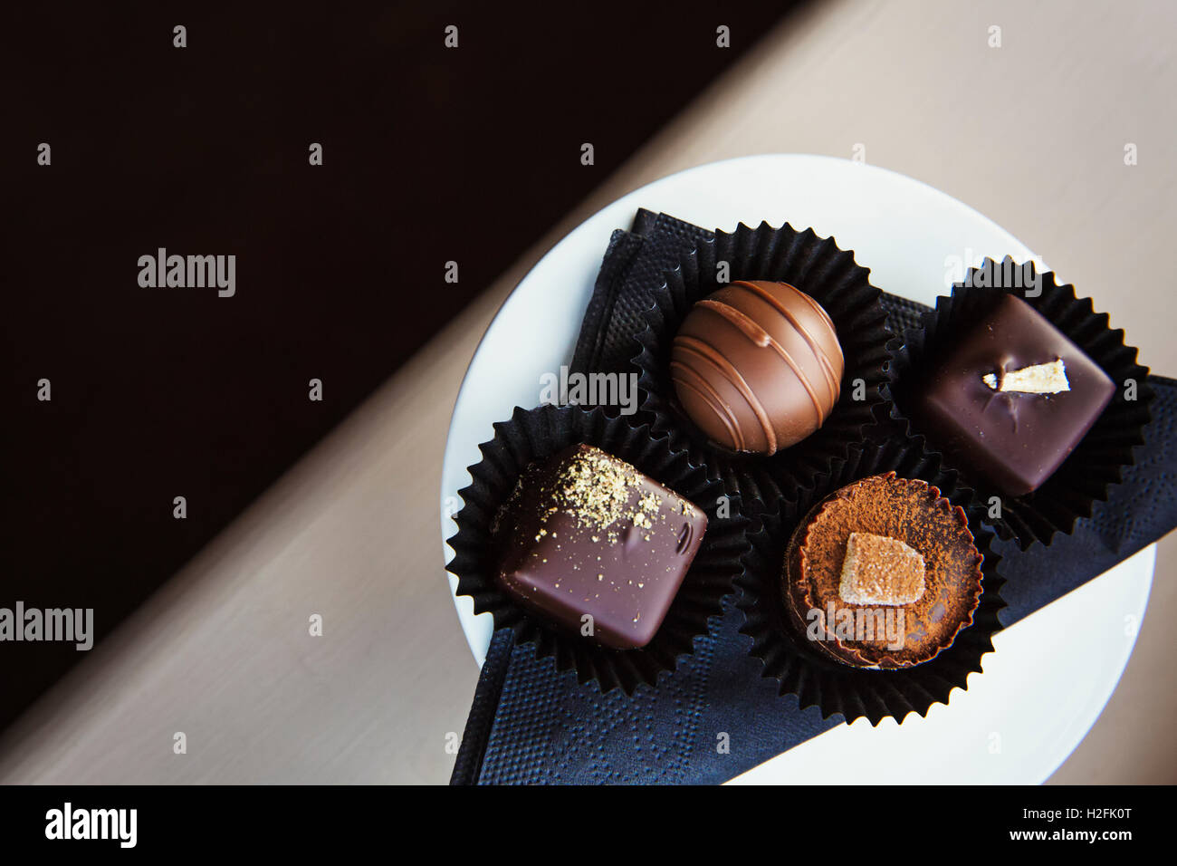 Assorted hand made chocolates on a plate. Overhead view Stock Photo - Alamy