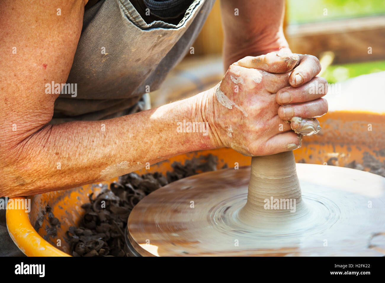 A woman potter working clay on a potter's wheel in her workshop Stock ...