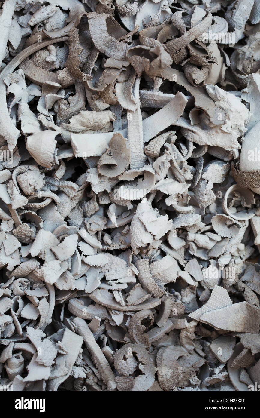 A heap of offcuts, curls of clay removed in the process of shaping ...