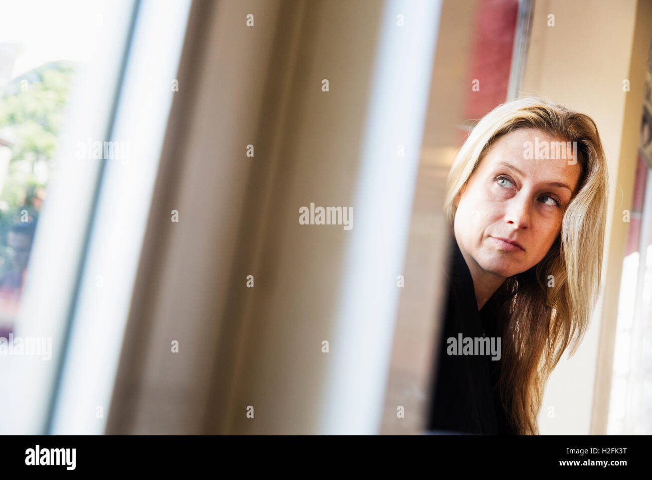 Portrait of a blonde woman looking sideways Stock Photo - Alamy