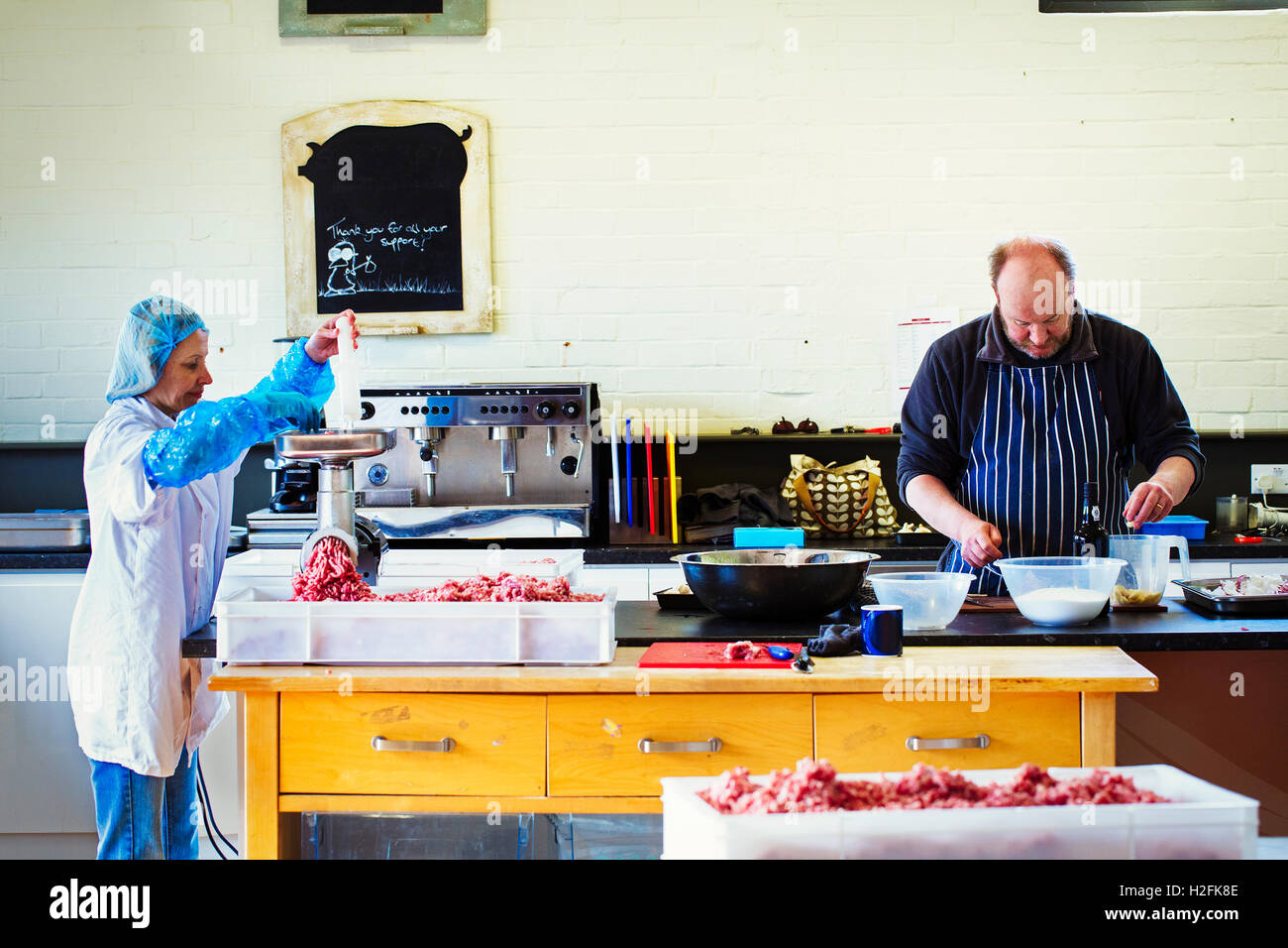 Woman wearing protective clothes and gloves and man wearing a striped ...