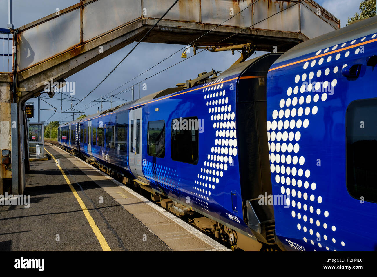 A local ScotRail commuter passenger train standing at Carluke Station ...