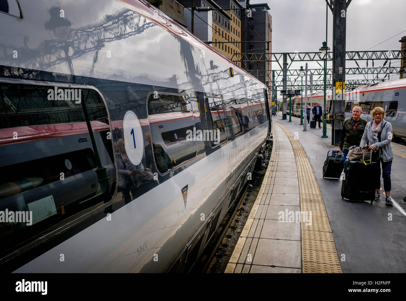 First class passengers alighting from a Virgin express passenger train ...