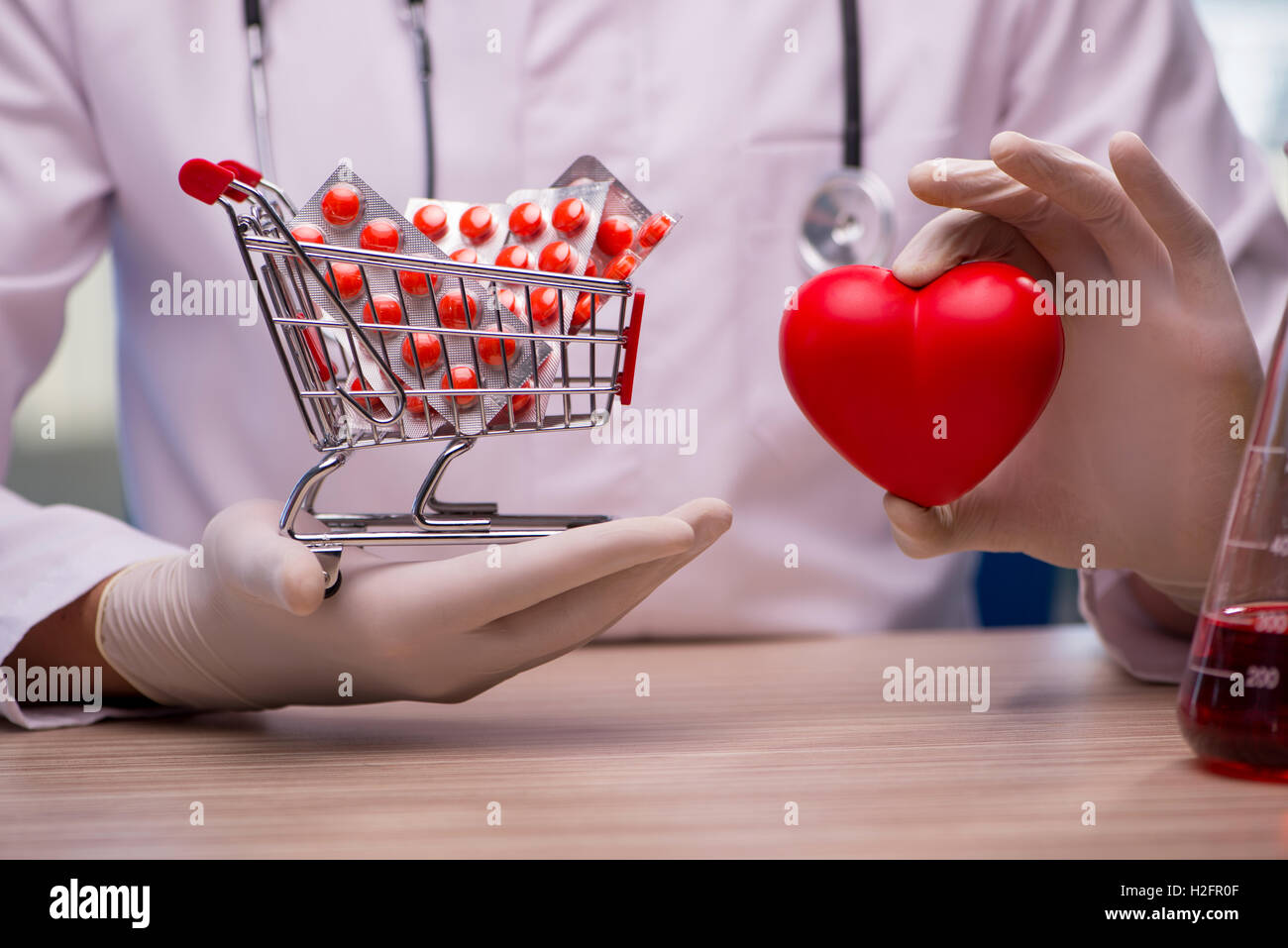 Doctor curing heart in medical concept Stock Photo - Alamy