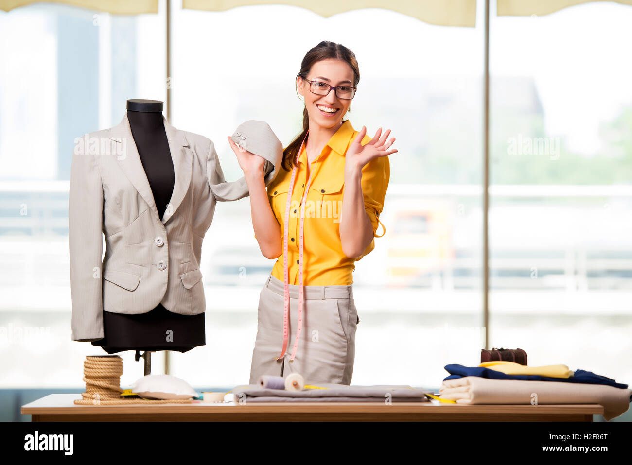 Woman tailor working on new clothing Stock Photo - Alamy