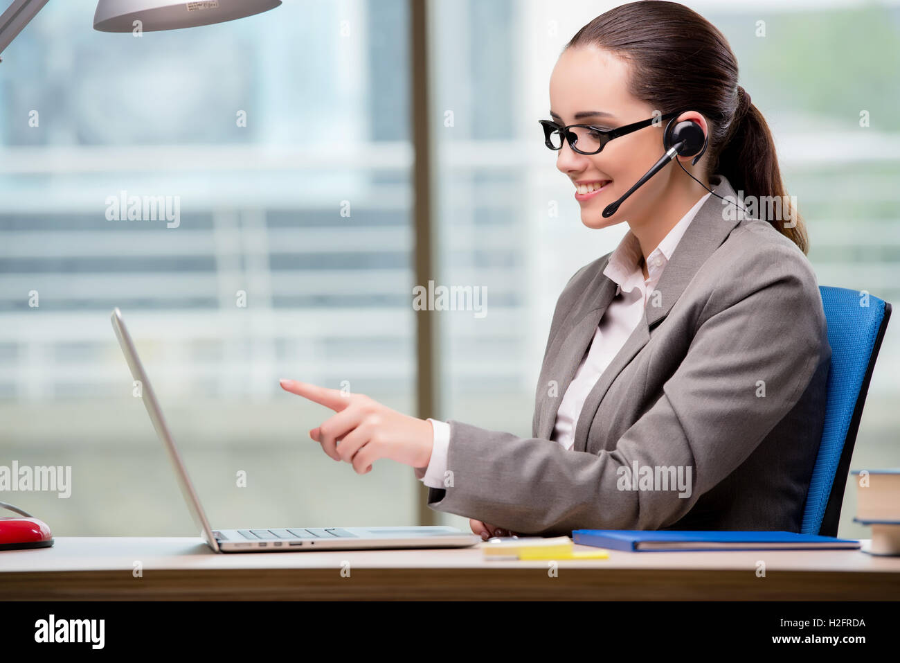 Call center operator working at her desk Stock Photo - Alamy