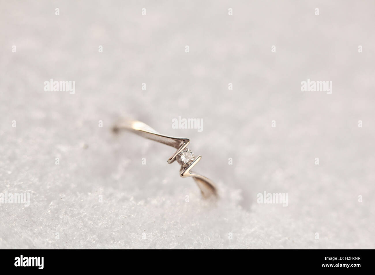 Beautiful engagement ring on snow Stock Photo - Alamy