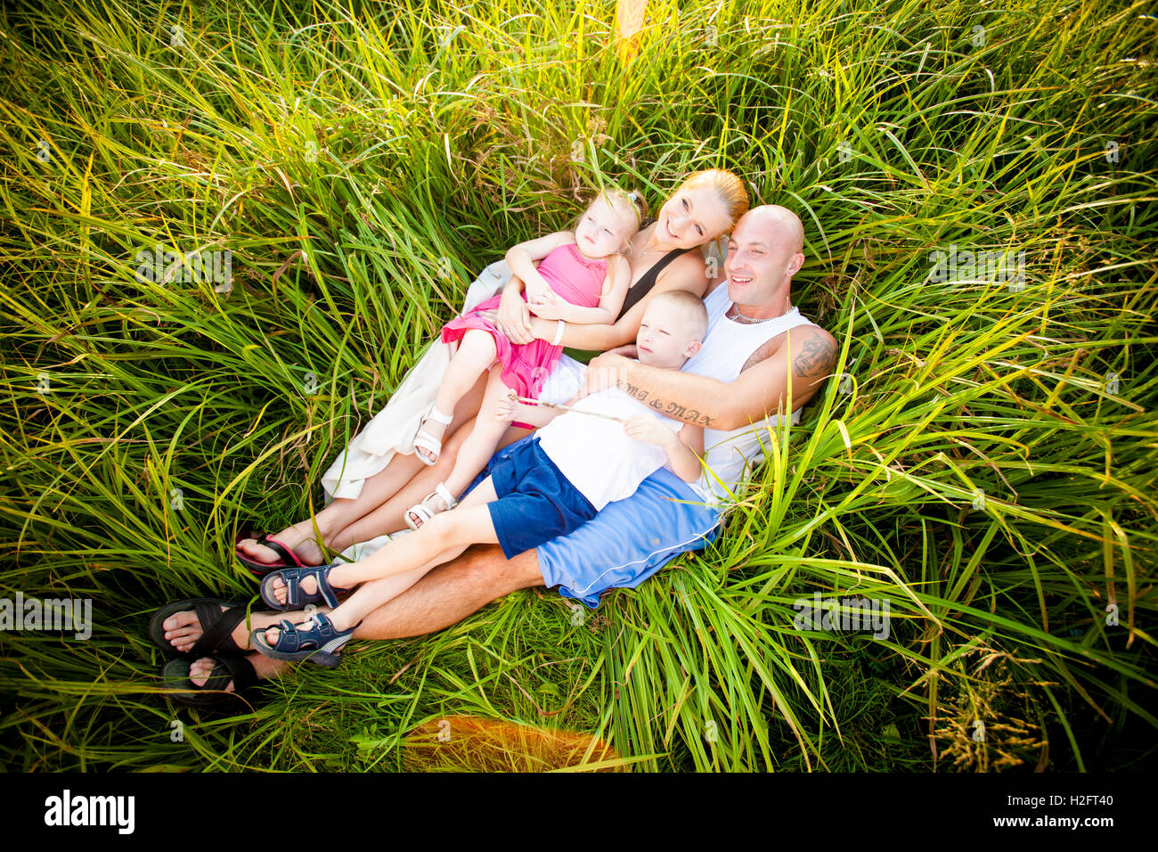Family having fun in a park during beautiful summer evening Stock Photo ...