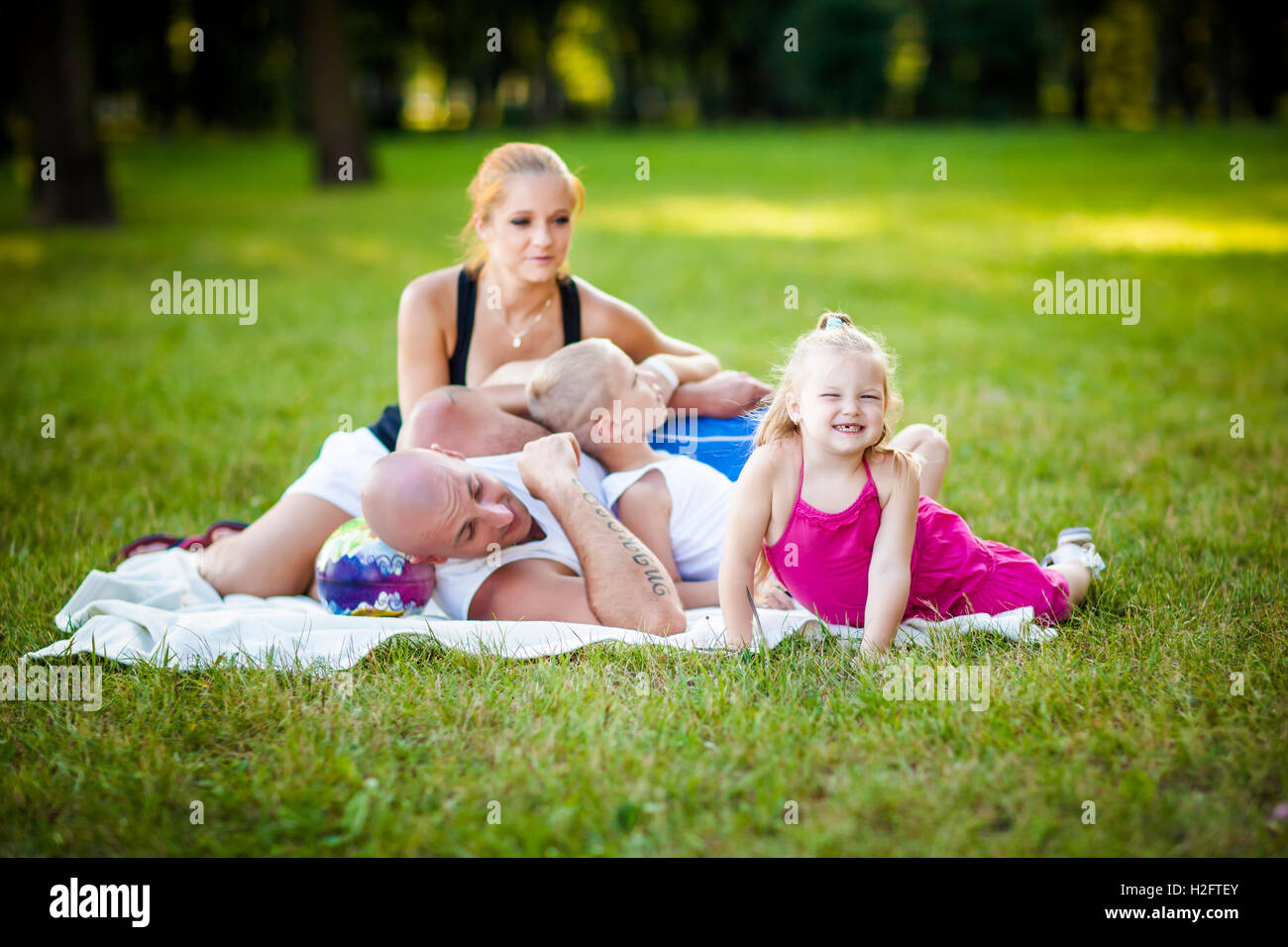 Family having fun in a park during beautiful summer evening Stock Photo ...