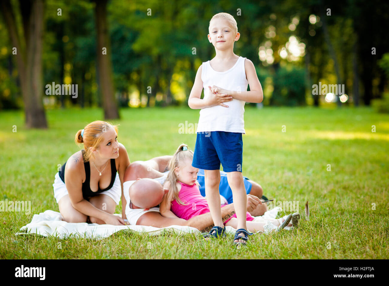 Family having fun in a park during beautiful summer evening Stock Photo ...