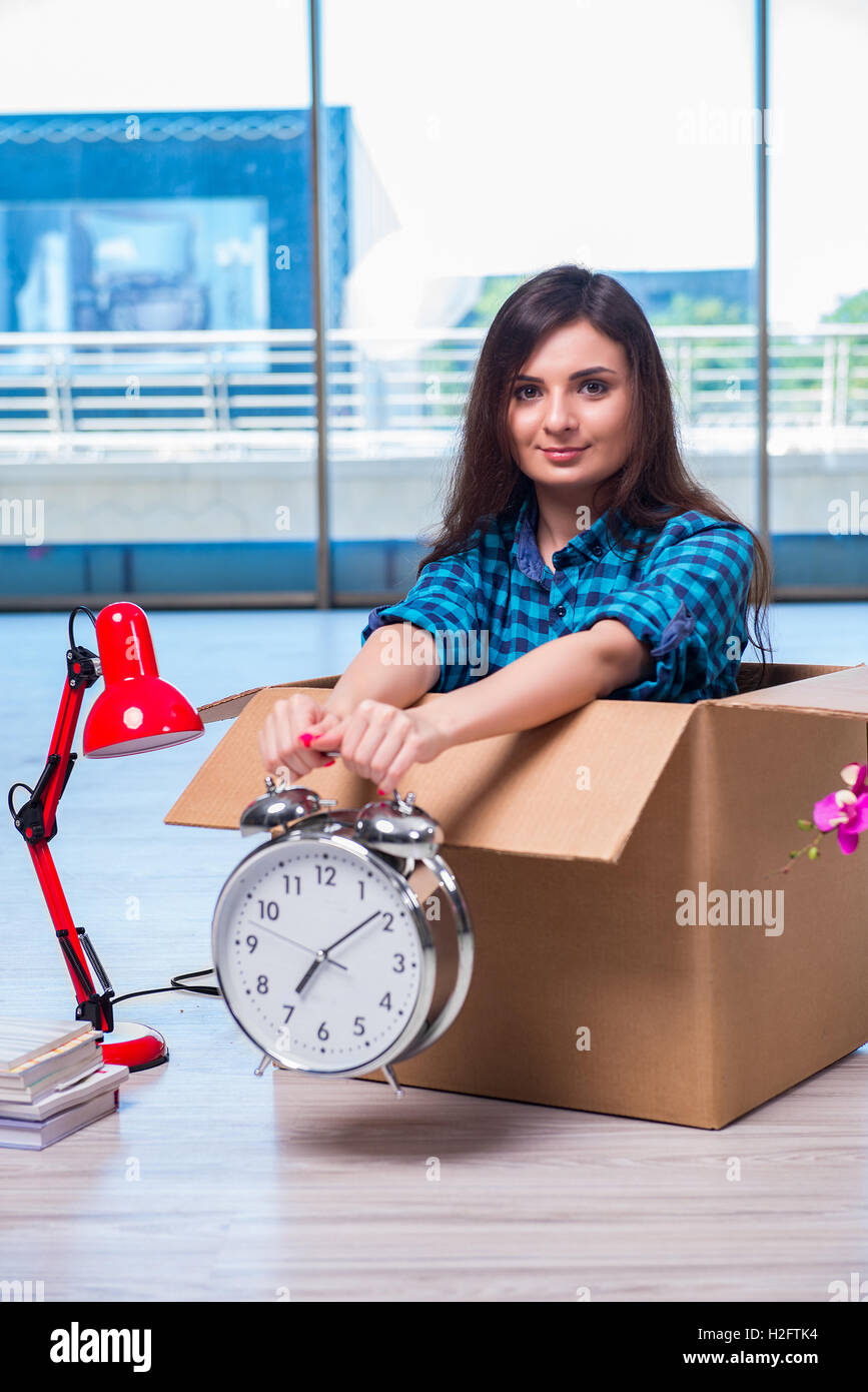 Young woman moving personal belongings Stock Photo - Alamy