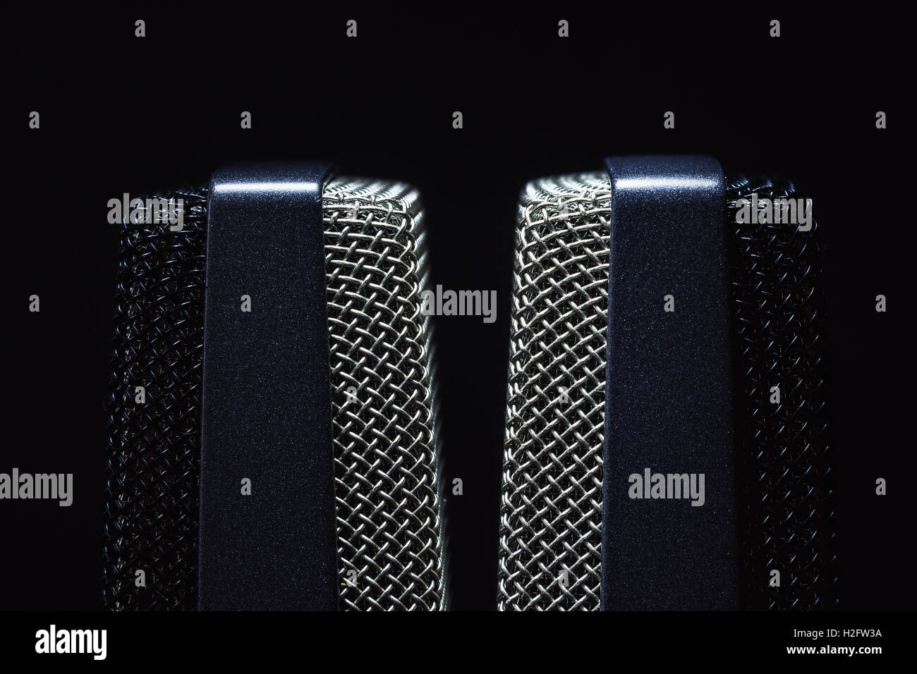 Details of two studio microphones, on black background Stock Photo - Alamy